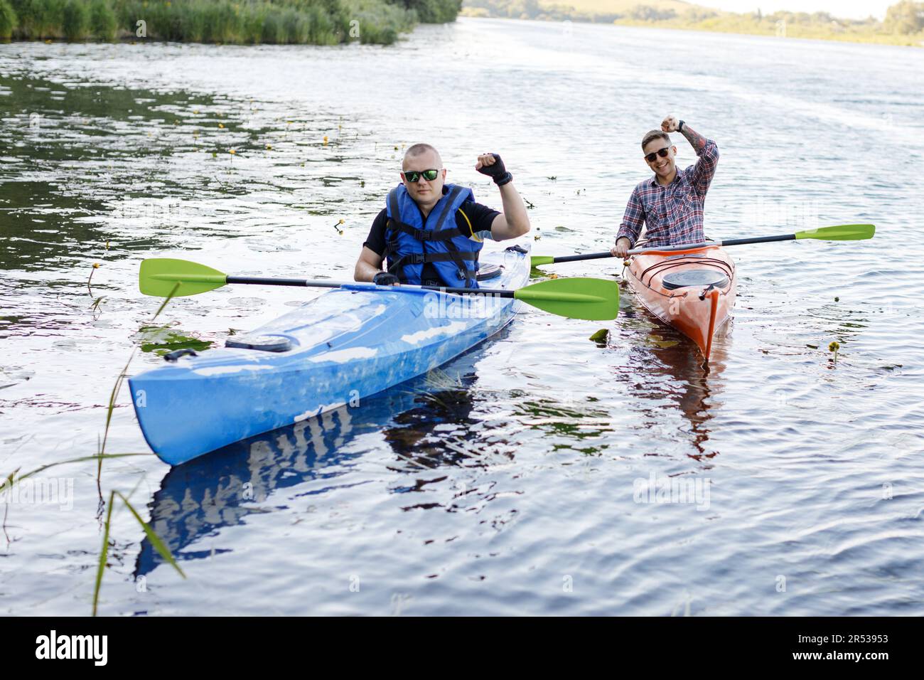 Kayaking on the river. Two adult men is sitting in a kayak and ...