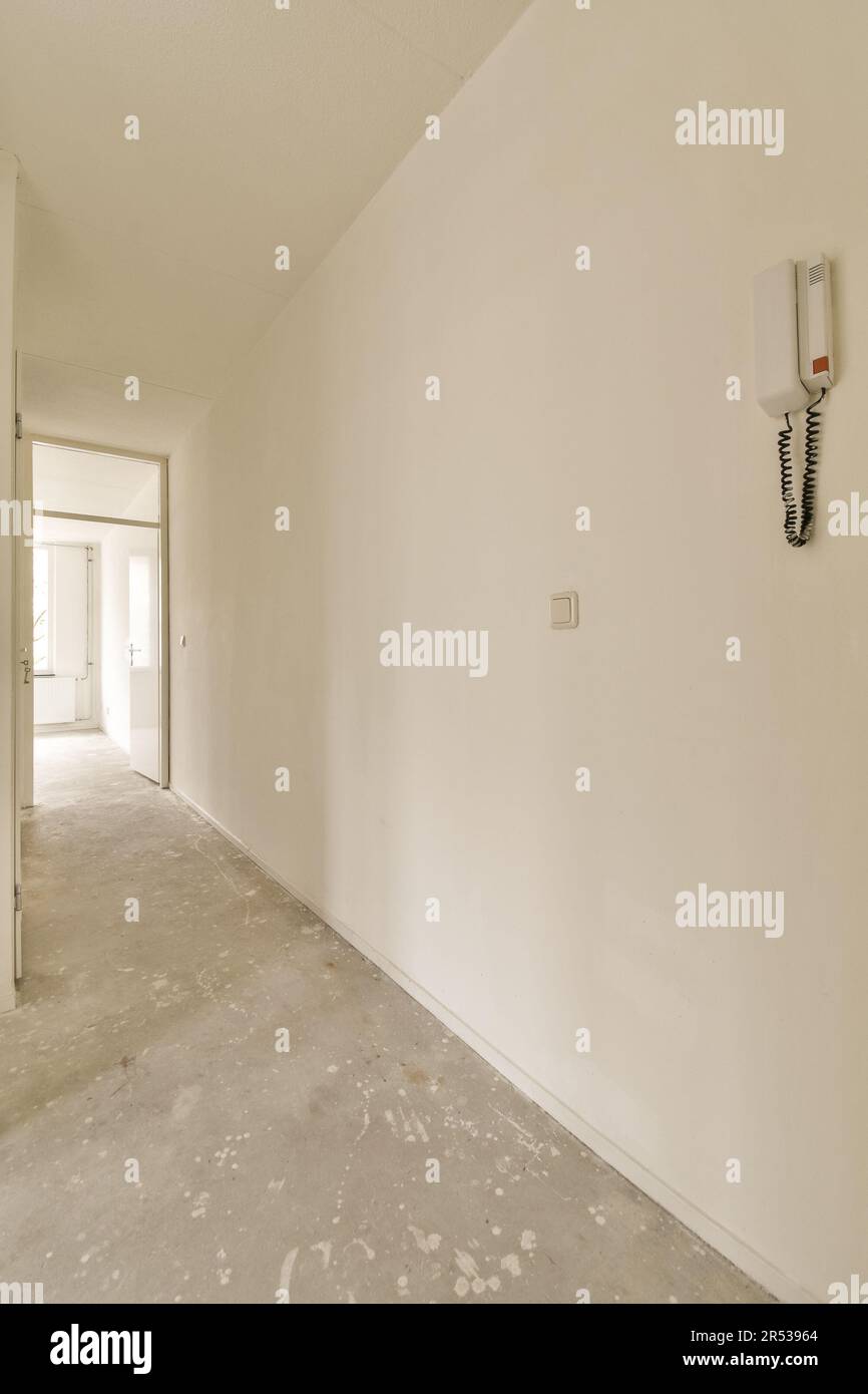 an empty room with no one on the wall, and there is a door to another ...