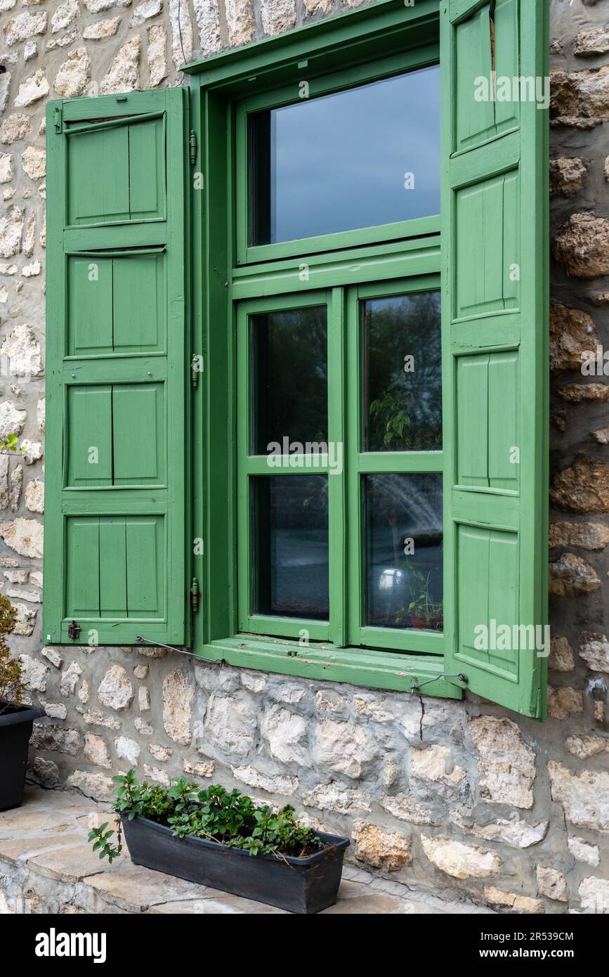 Green wooden shutters of an old cottage. protects the windows close ...