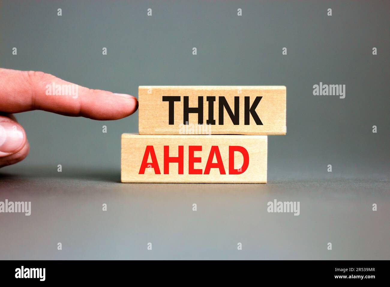 Think ahead symbol. Concept words Think ahead on wooden blocks on a beautiful grey table grey ...