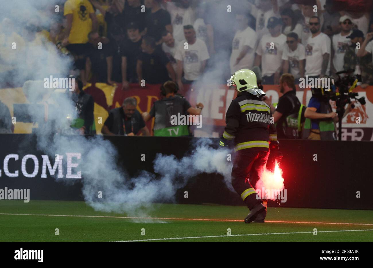 A steward removes a flare from the pitch hi-res stock photography and ...