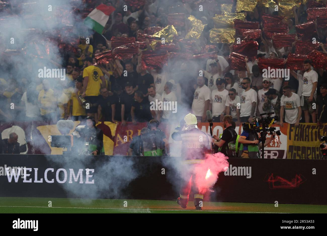 A steward removes a flare from the pitch hi-res stock photography and ...