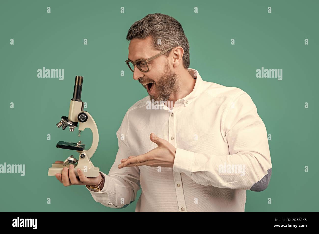 amazed man microscope for invention. photo of man holding microscope ...