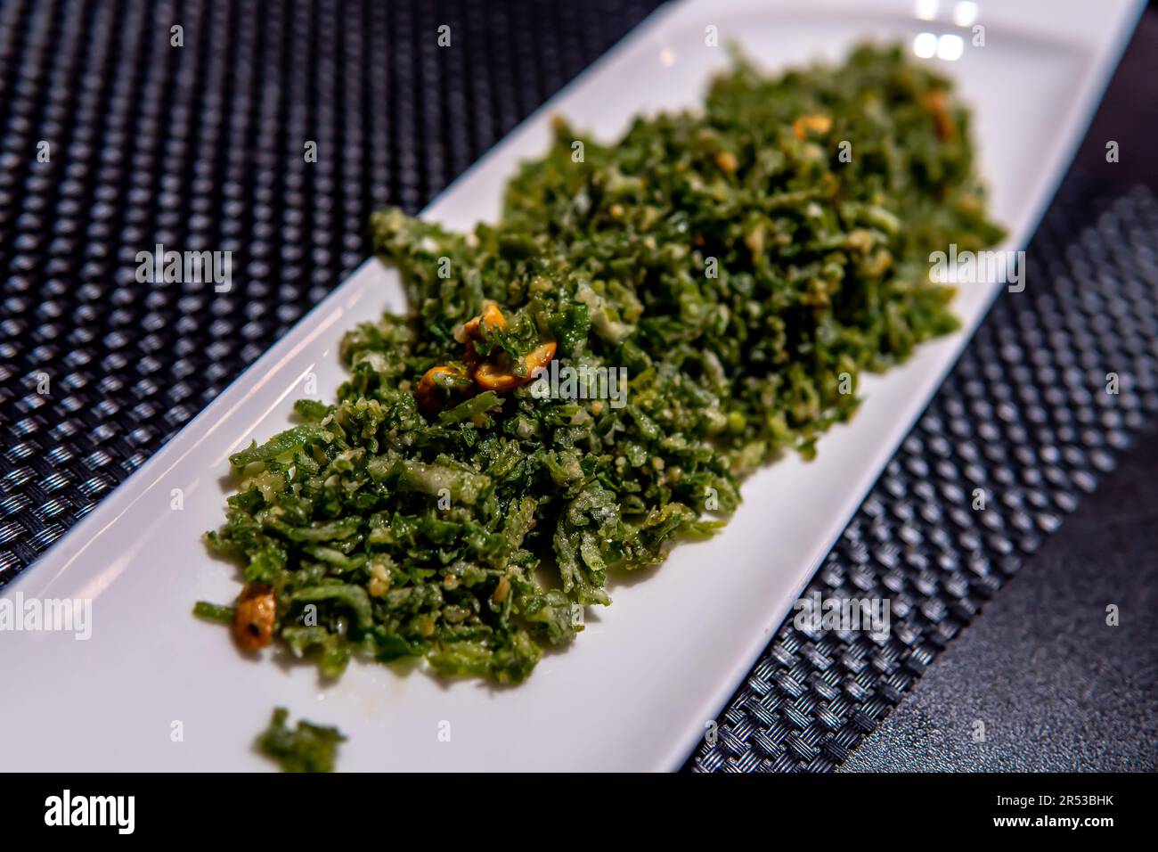 The platter looks vivid green from the side and is garnished with a ...
