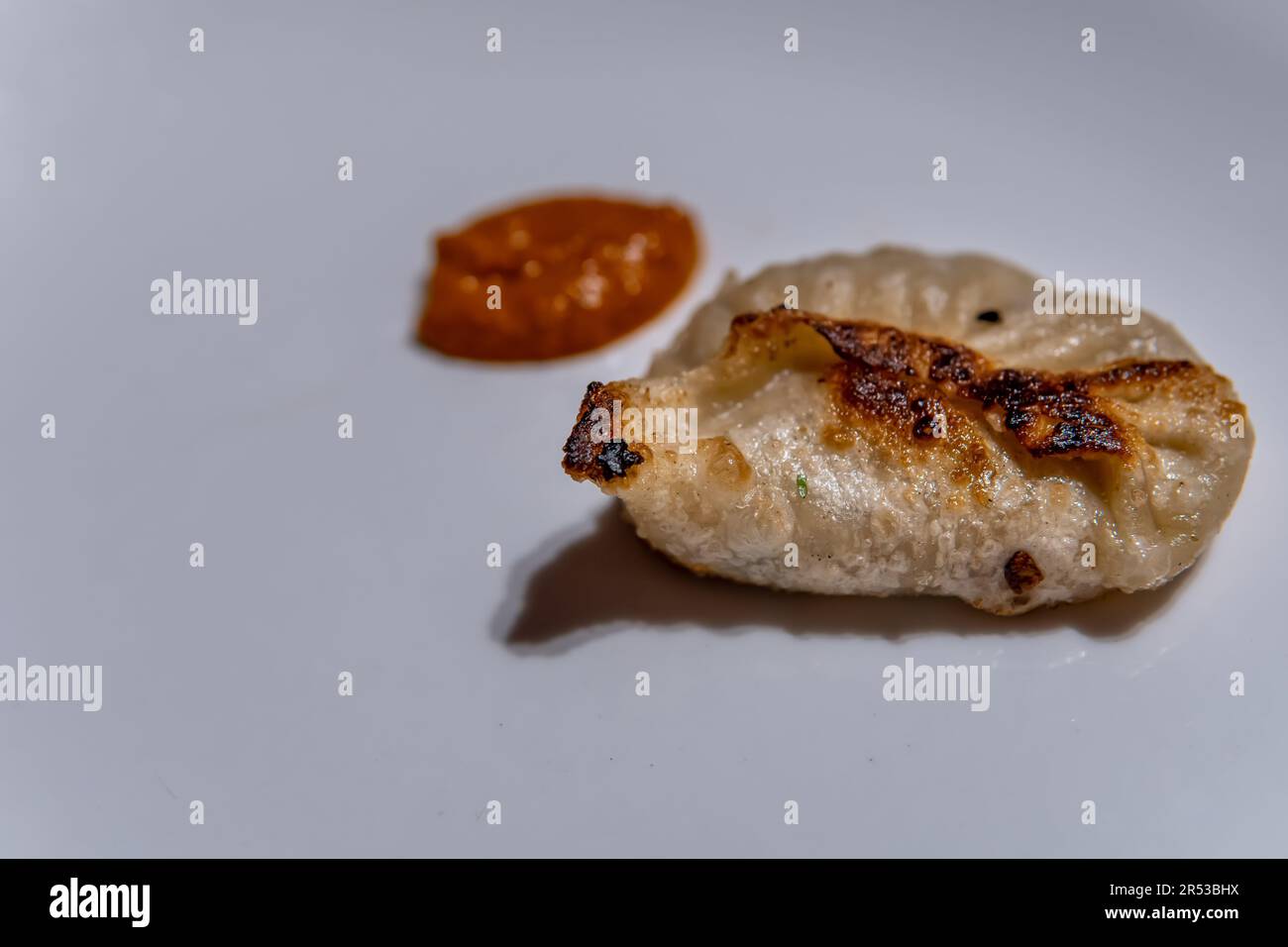 One fried momo served with momo chutney and loaded with flavourful momo ...