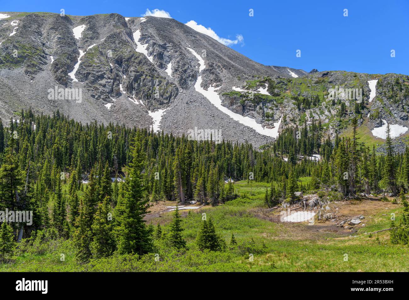 Spring Mountain - A Spring day view of a high mountain peak surrounded ...