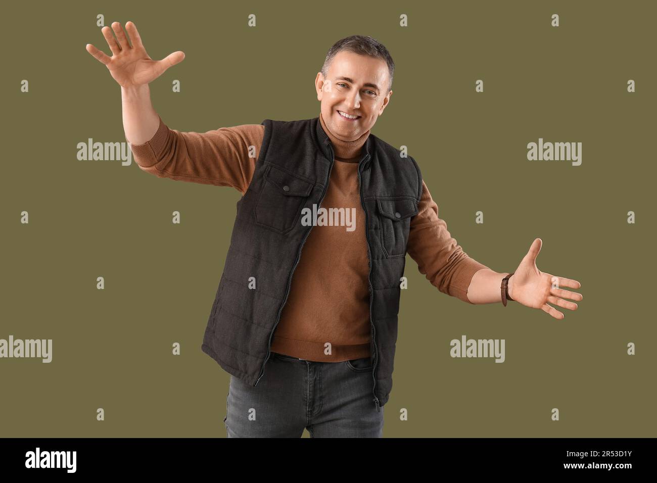 Mature man opening arms for hug on green background. Hello concept ...