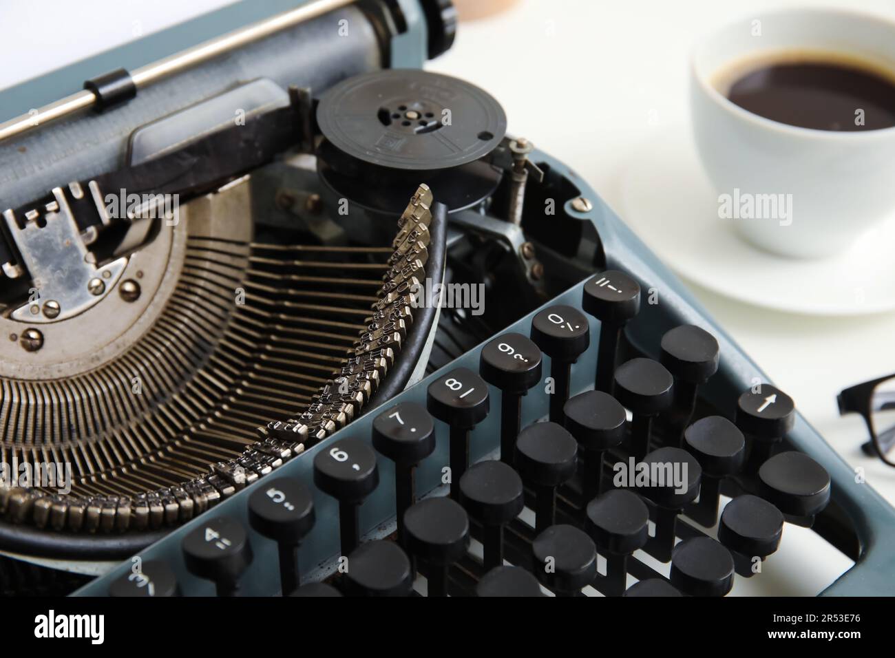 Vintage typewriter with cup of coffee on white background, closeup ...