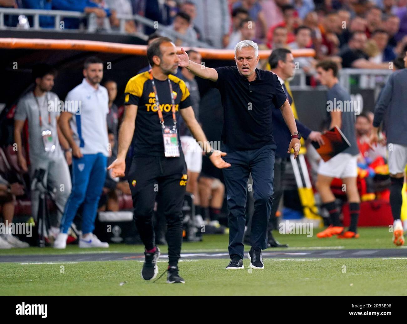 Roma manager Jose Mourinho (right) gestures to a member of his coaching ...