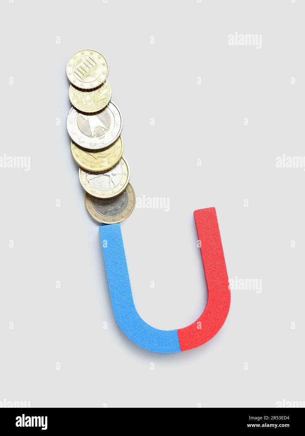 Magnet with coins on white background. Attracting investments concept ...