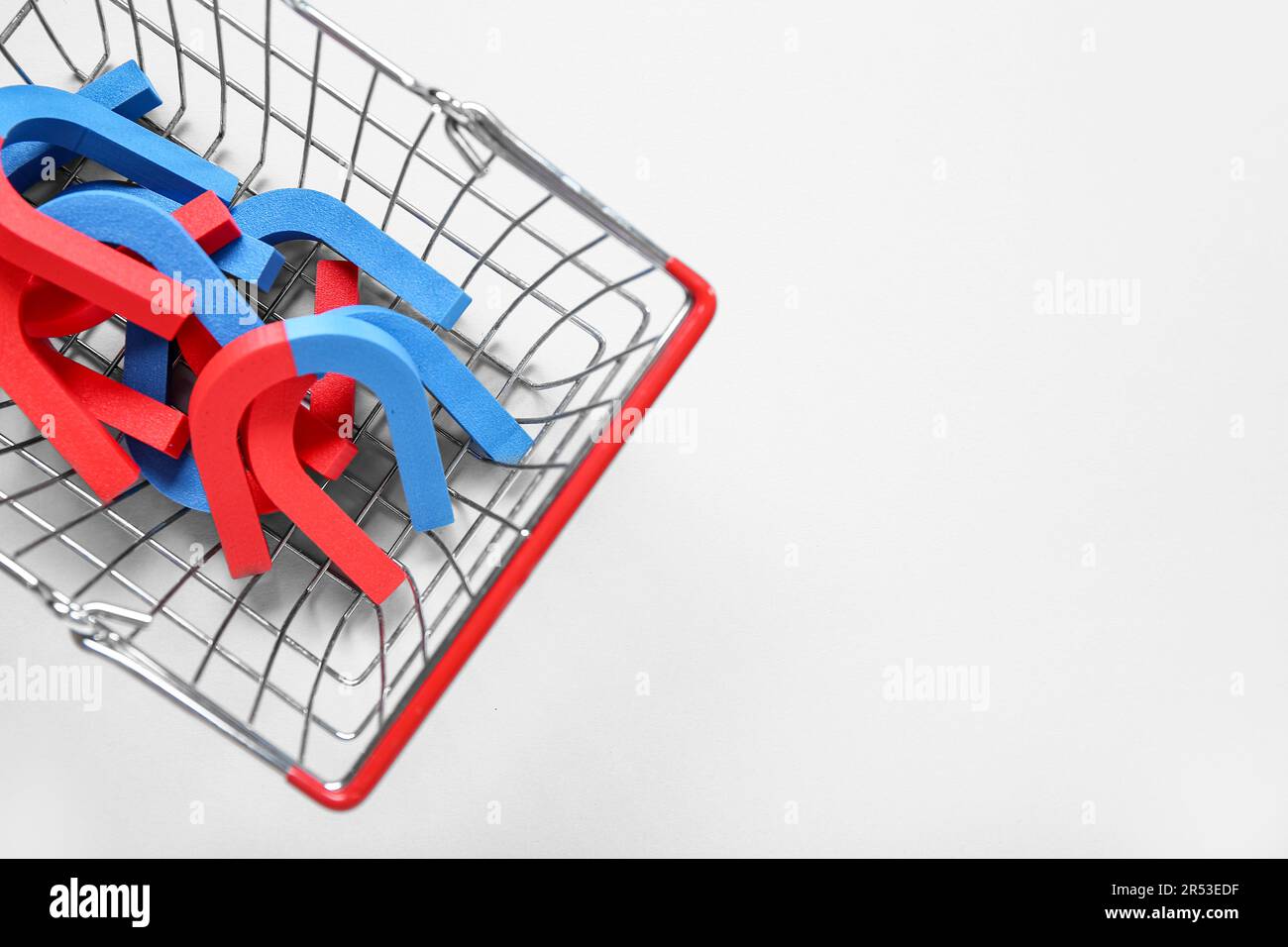 Mini trolley with magnets on white background Stock Photo - Alamy