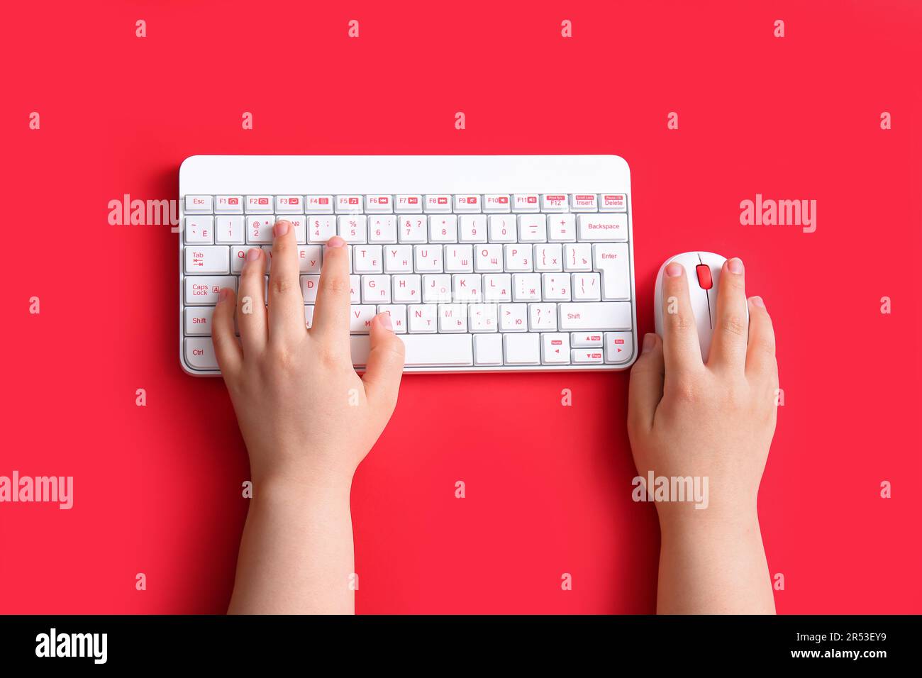 Female hands with modern computer keyboard and mouse on red background Stock Photo - Alamy