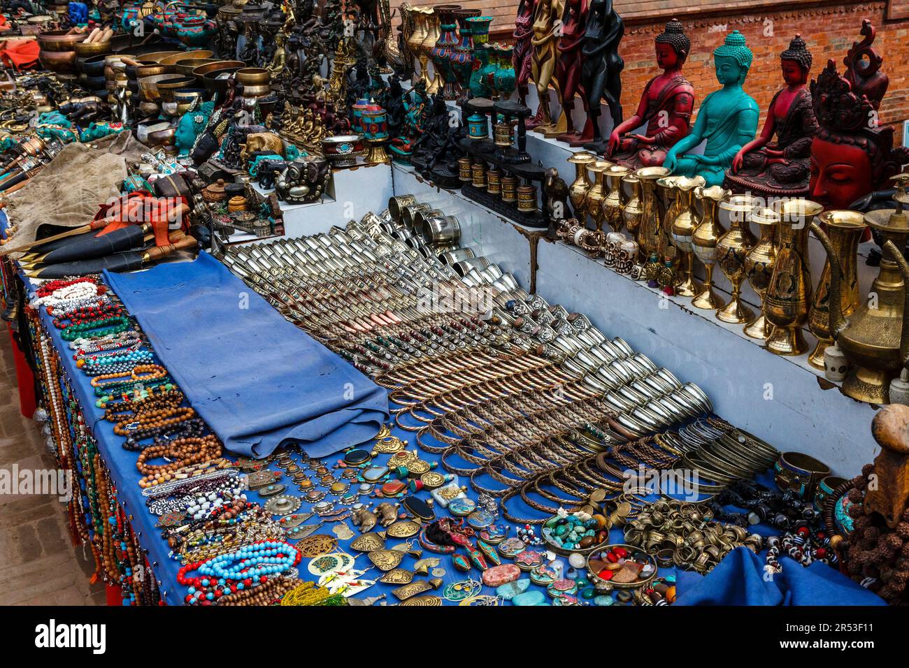 Tourist market stall with Nepalese souvenirs and Buddha statues for ...