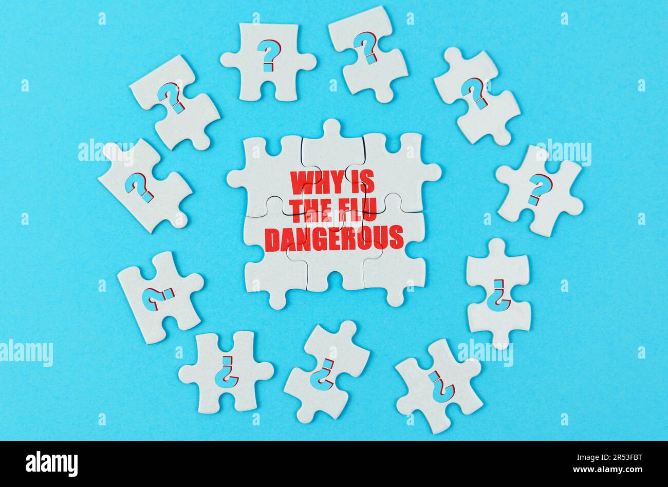 Medical concept. On a blue surface are puzzles with a question mark, in ...