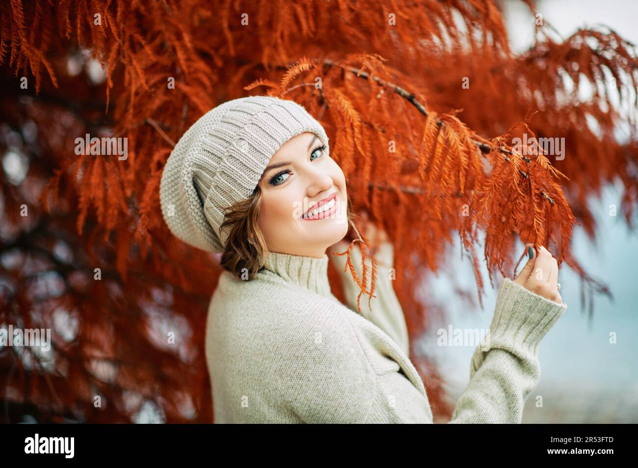 Autumn portrait of pretty young woman with golden bald cypress tree ...