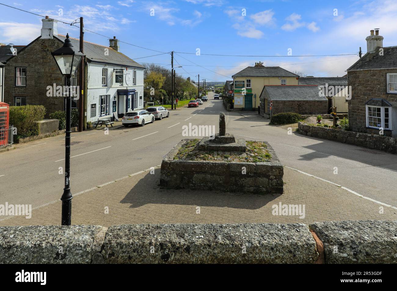 The St Buryan Inn or pub or public house and an old stone cross, St ...