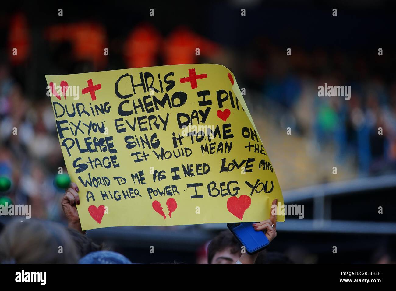 A fan holds up a sign ahead of Coldplay in concert at the Manchester ...