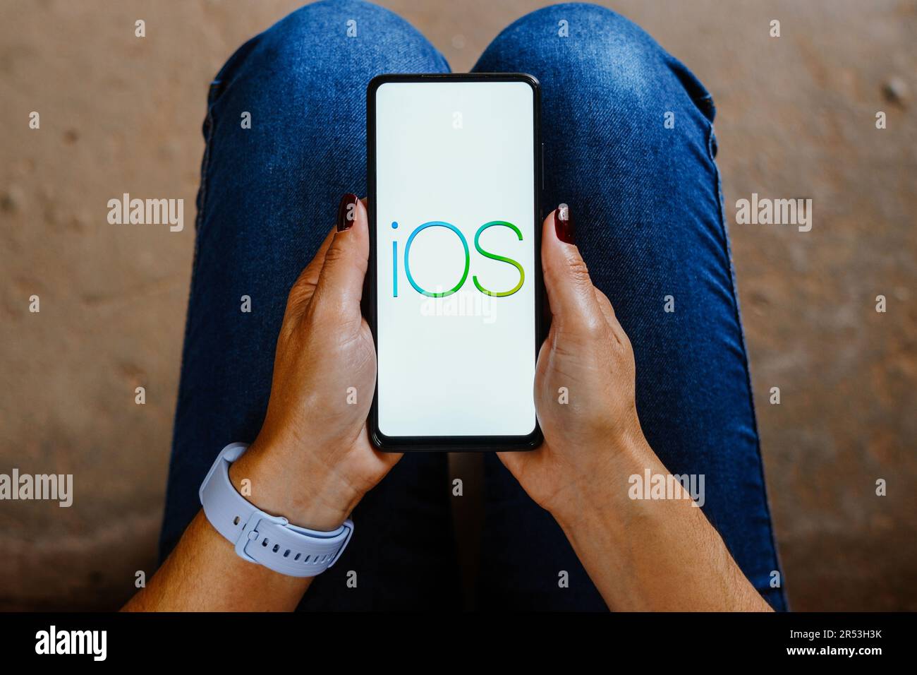 In this photo illustration, the iOS logo is displayed on a smartphone ...