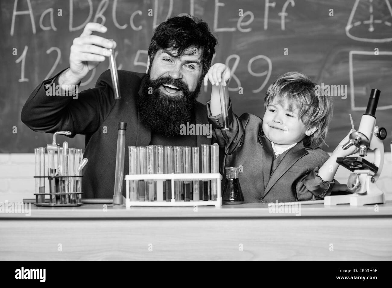 Back to school. Chemistry experiment. Teacher child test tubes ...