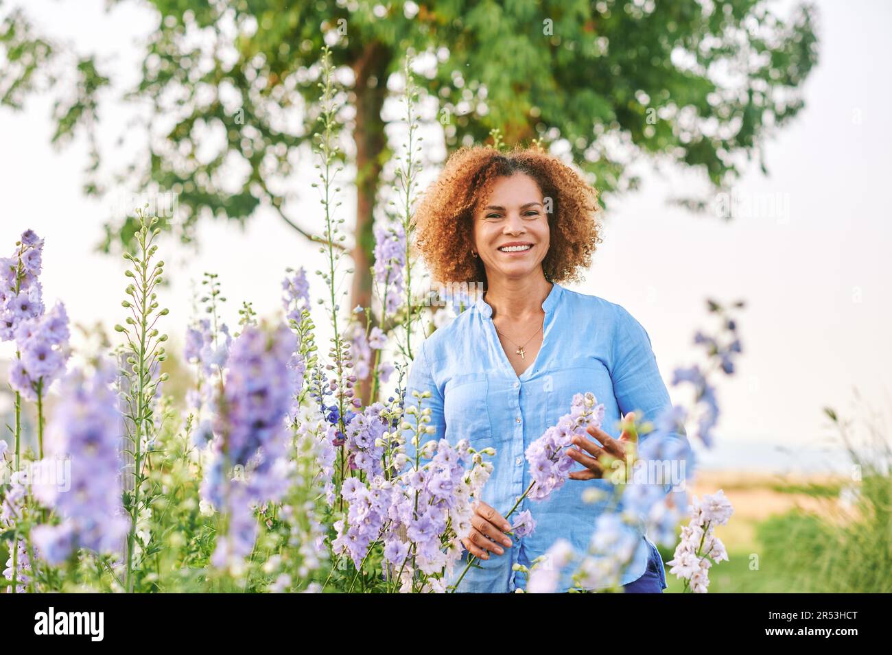Outdoor Portrait Of Beautiful 50 Year Old Woman Enjoying Nice Day In