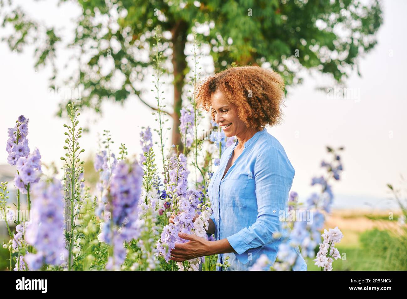 Outdoor Portrait Of Beautiful 50 Year Old Woman Enjoying Nice Day In