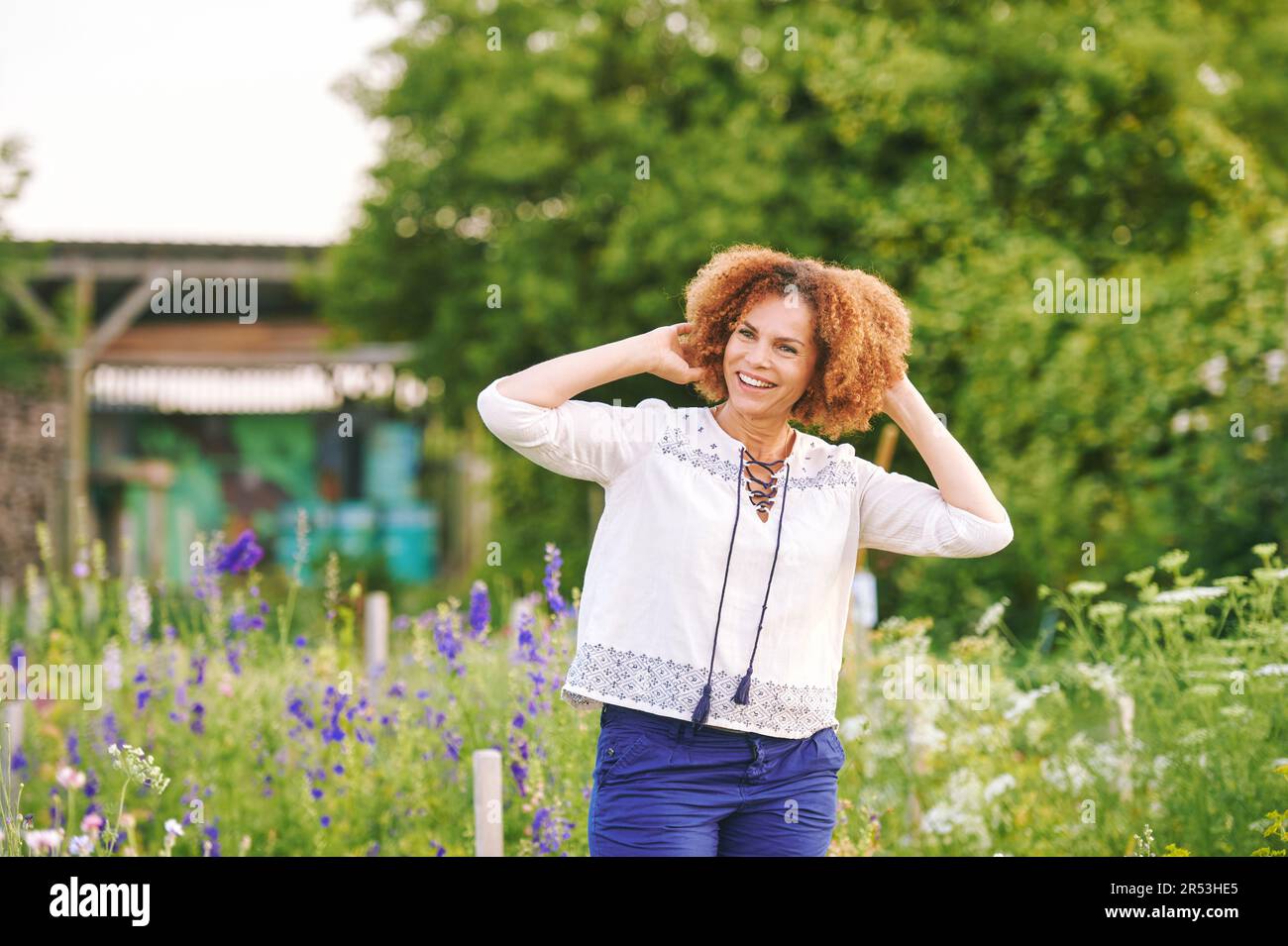 Outdoor Portrait Of Beautiful 50 Year Old Woman Enjoying Nice Day In