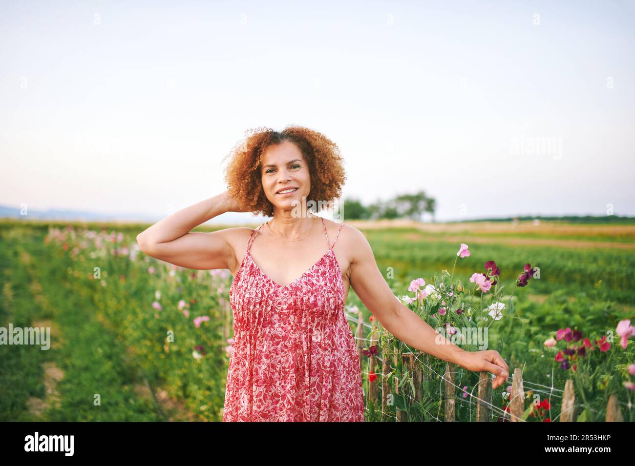 Outdoor portrait of beautiful middle age woman enjoying nice suuny ...