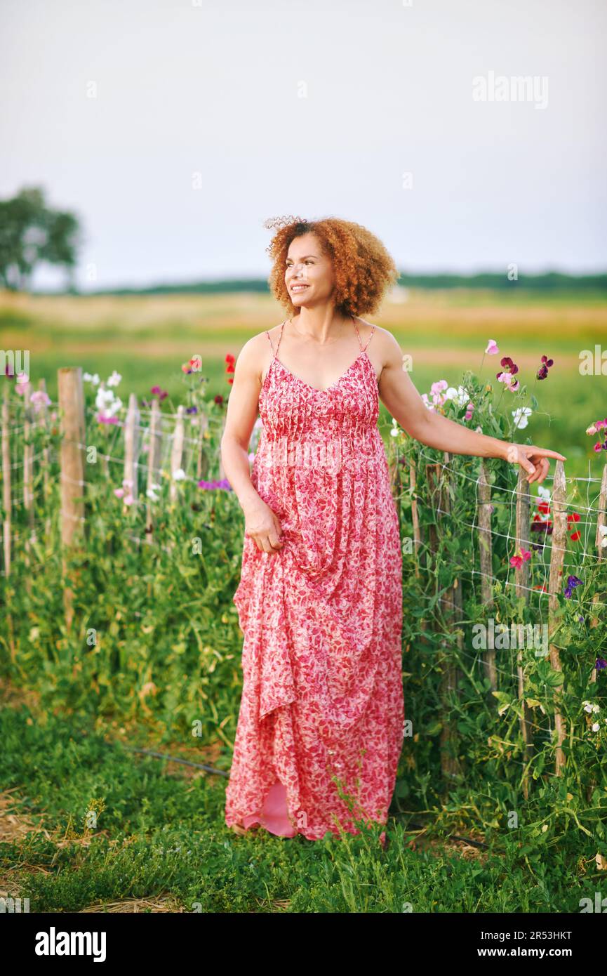Outdoor portrait of beautiful middle age woman enjoying nice suuny ...