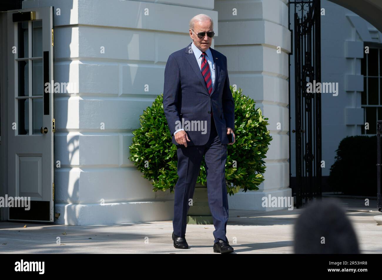 President Joe Biden walks out of the White House before he talks with ...