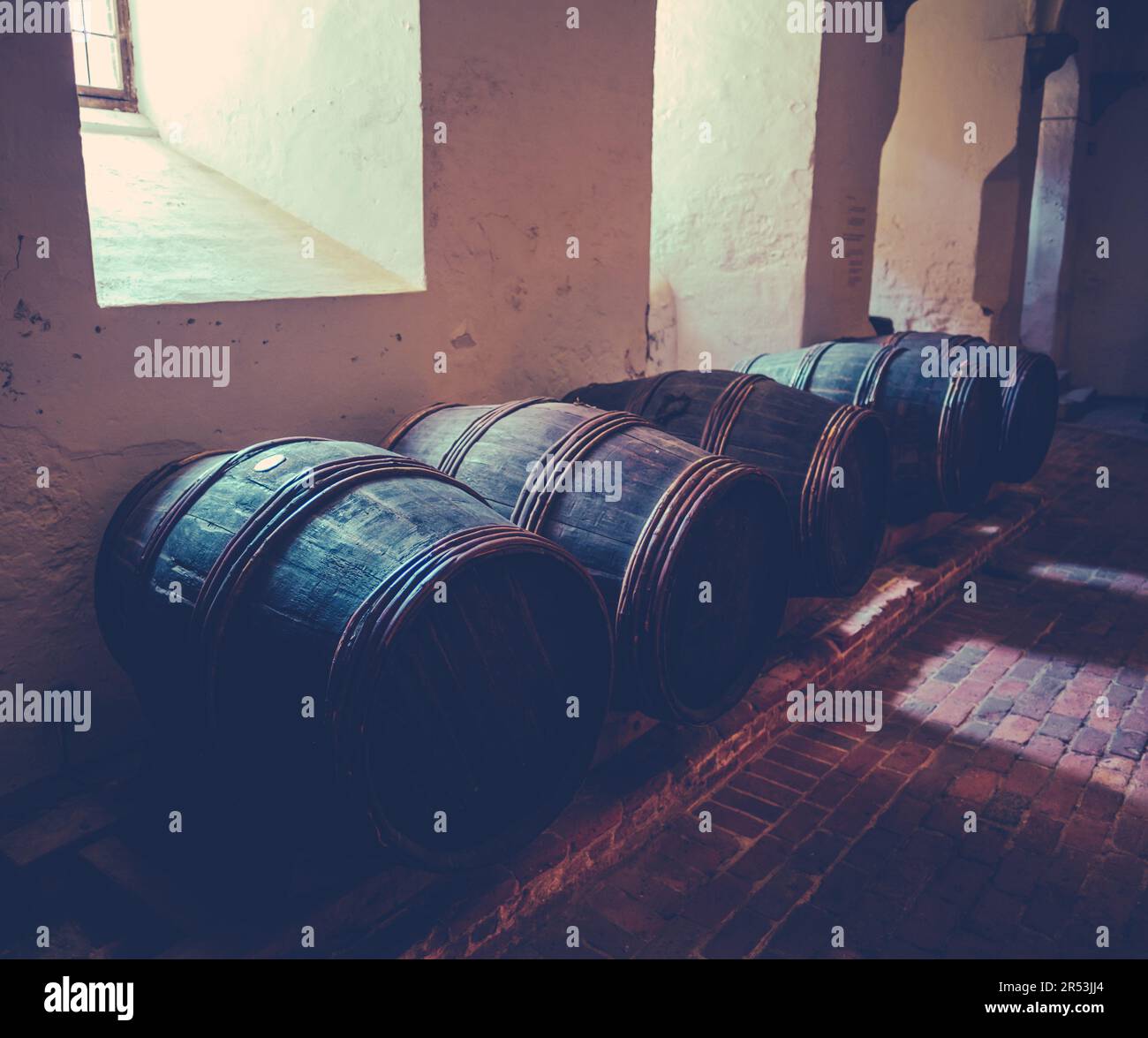 Barrels Of Wine Aging In A Rustic Cellar Stock Photo - Alamy