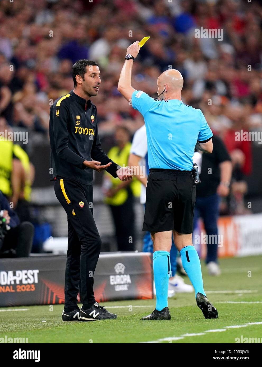 Roma assistant manager Salvatore Foti is shown a yellow card by referee ...