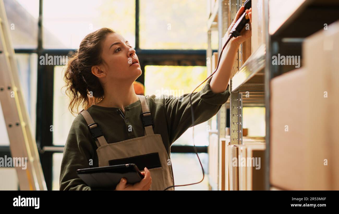 Small Business Manager Scanning Barcode Using Tablet And Scanner During