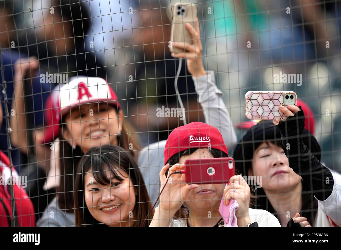 Fans of Los Angeles Angels' Shohei Ohtani try to get a photo of Ohtani after the team's 12-5 win ...