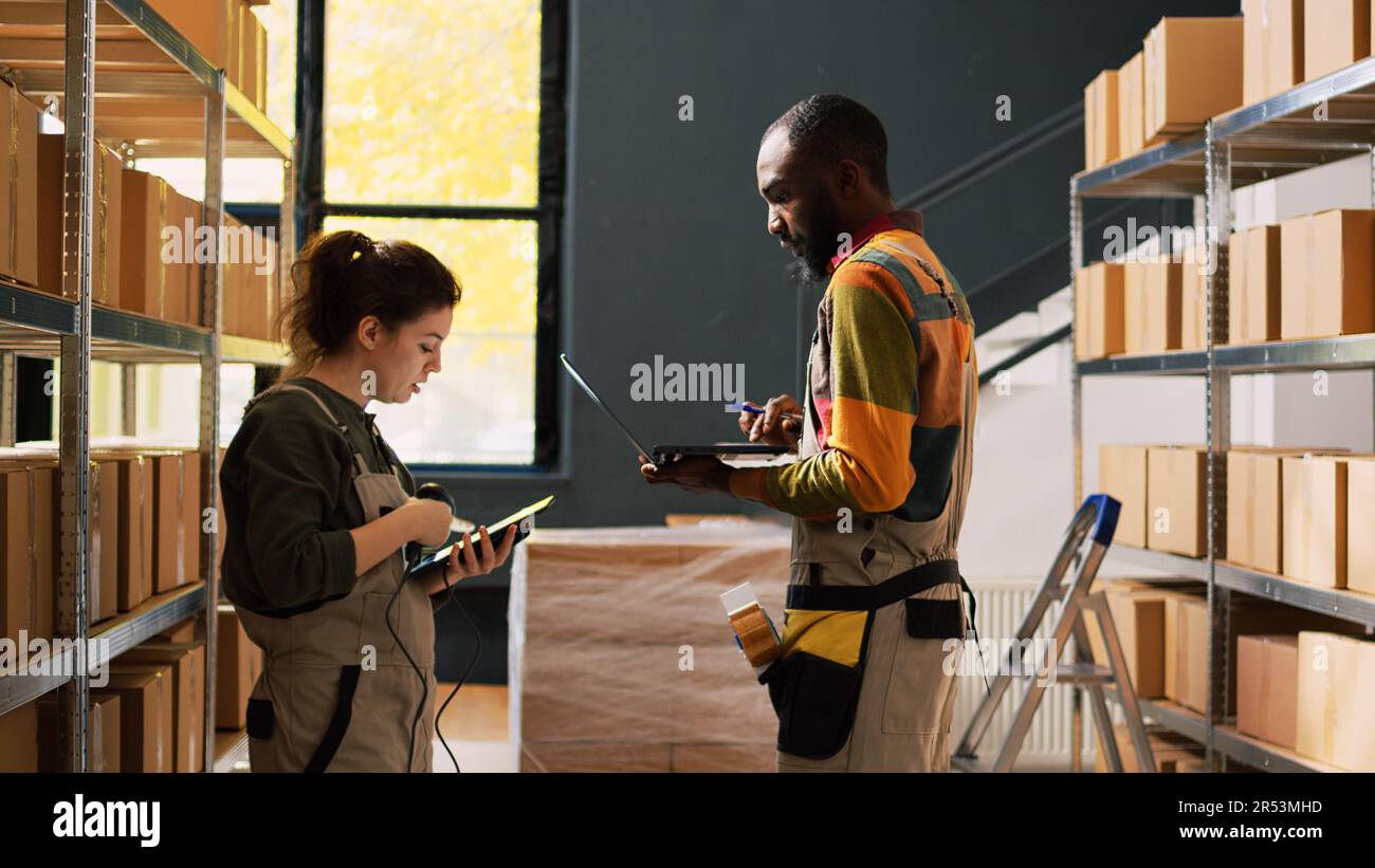 Depot workers doing products inventory on tablet, inspecting ...