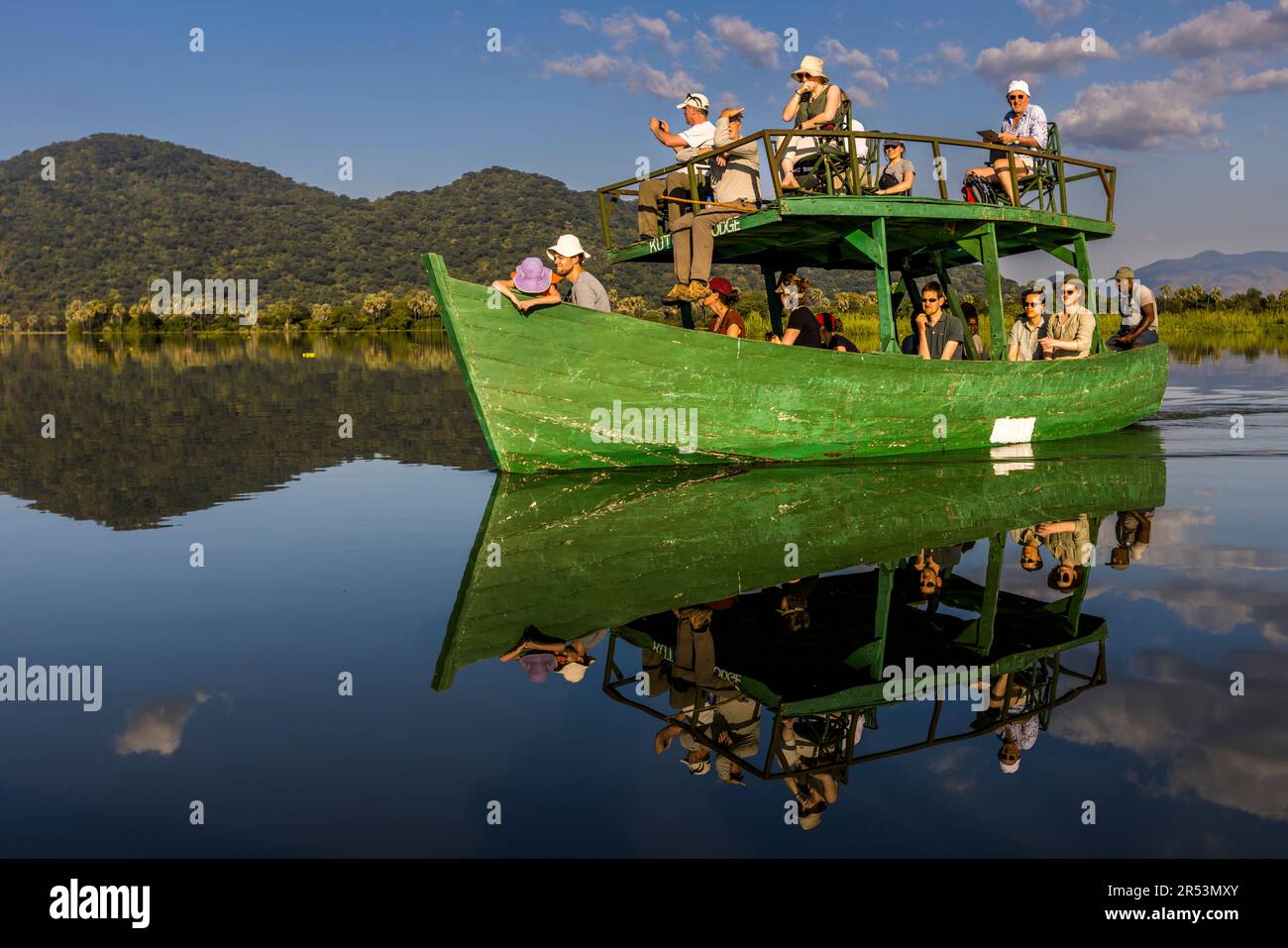 Guided boat tour across the Shire River. Evening atmosphere on the ...