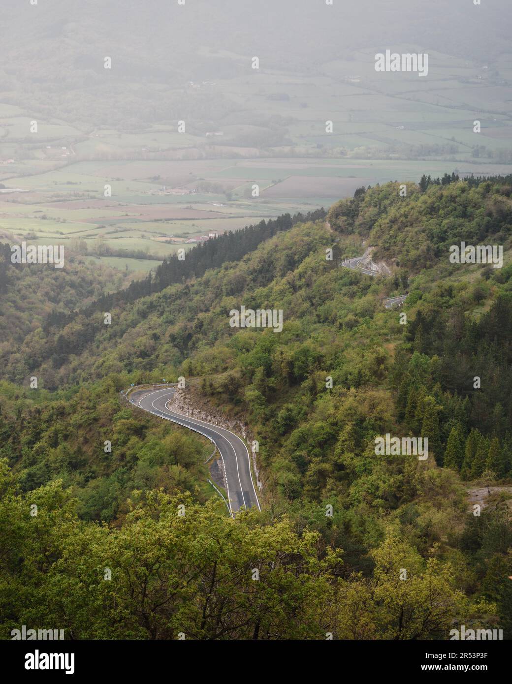 Winding road of the Barrerilla mountain pass through the forest. On the ...
