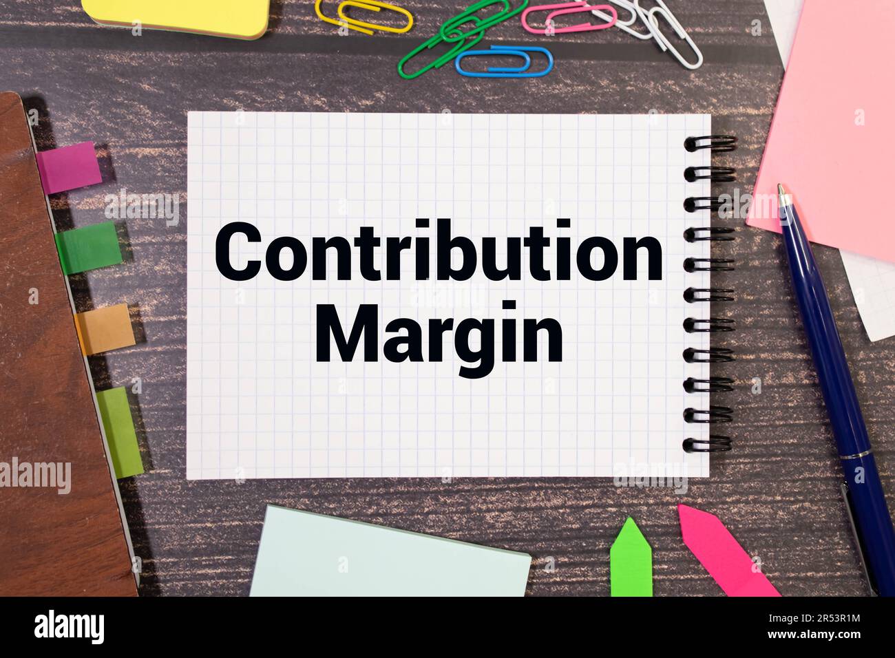Text CONTRIBUTION MARGIN on Notebook and office tools on the gray ...