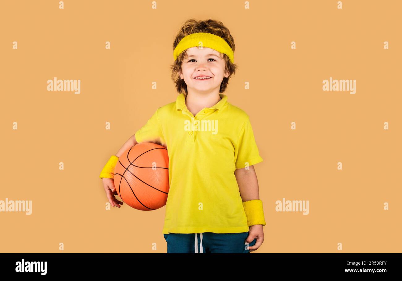 Little basketballer. Smiling sporty child with basketball. Little boy ...