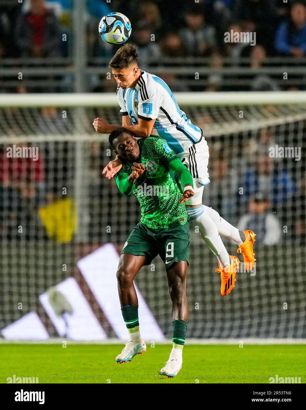 Argentina's Valentin Gomez, top, heads the ball over Nigeria's Salim ...