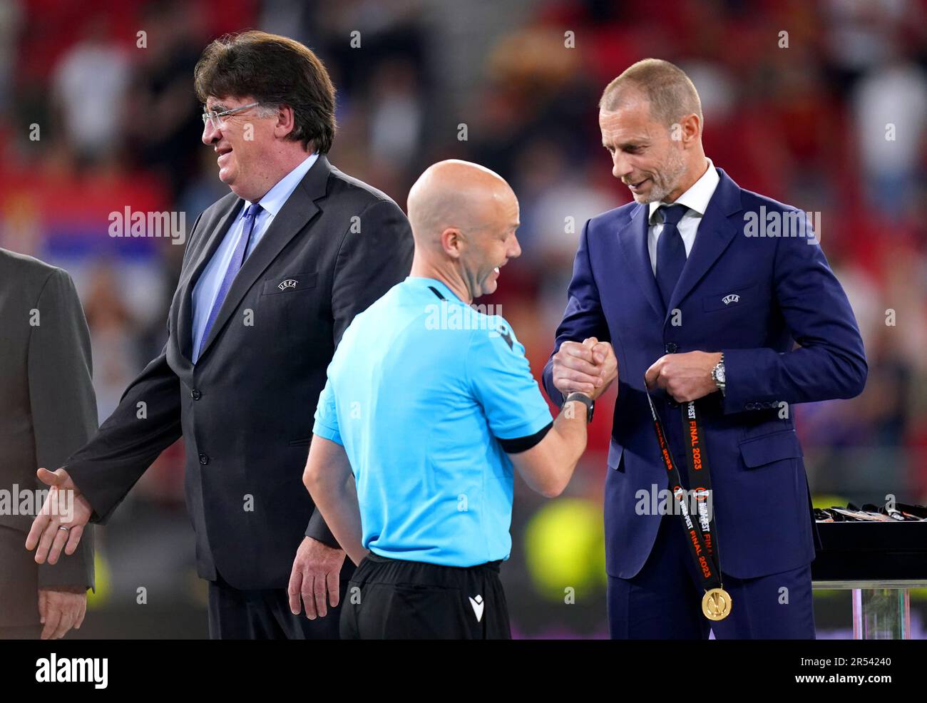 Referee Anthony Taylor shakes hands with the President of UEFA ...