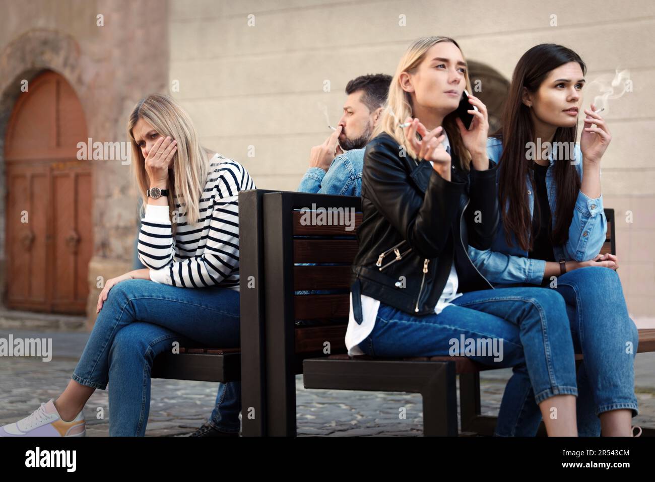 People smoking cigarettes at public place outdoors Stock Photo - Alamy