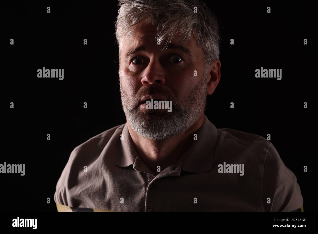 Frightened victim on black background. Hostage taking Stock Photo - Alamy