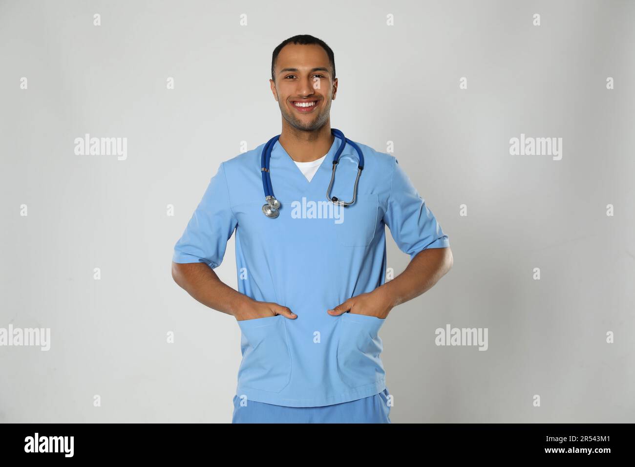 Doctor or medical assistant (male nurse) in uniform with stethoscope on ...