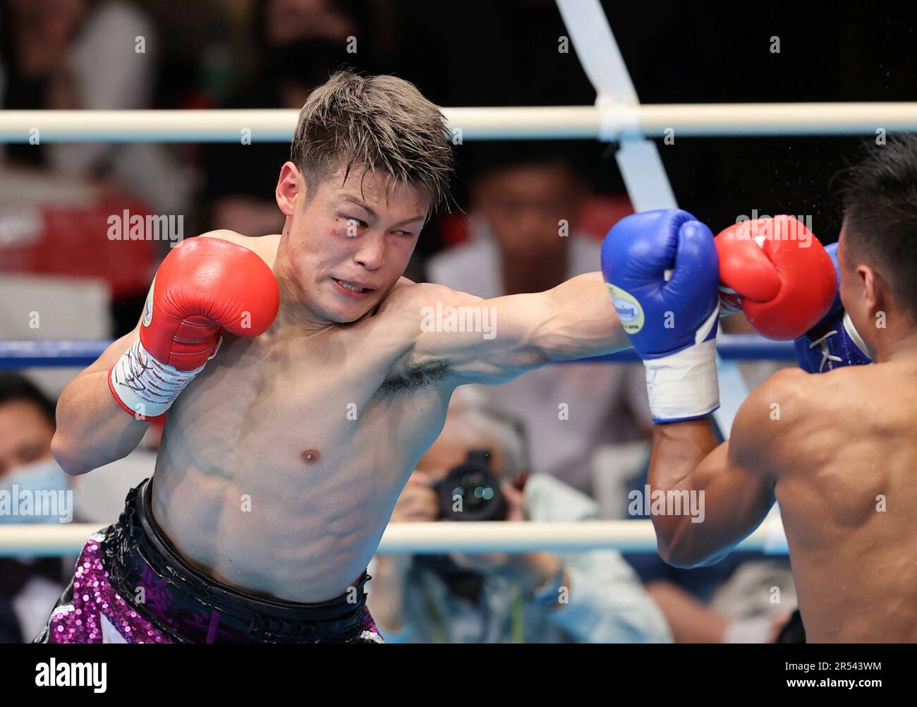 Hayato Tsutsumi of Japan (L) punches Joe Santisima of Philippines ...