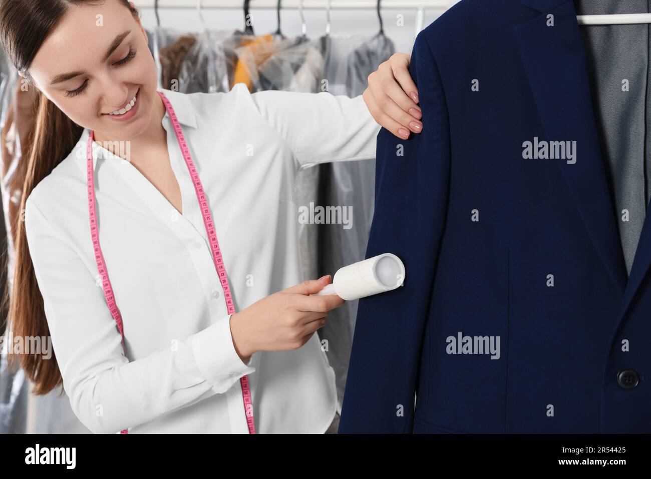 Woman using lint roller hi-res stock photography and images - Alamy