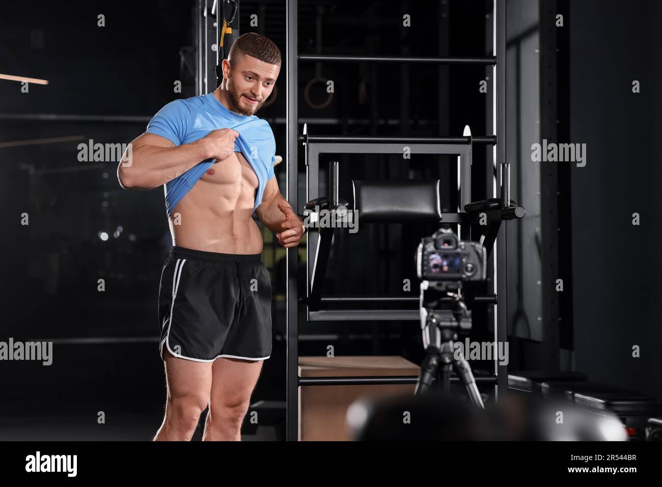 Man showing his abs on camera at gym. Online fitness trainer Stock ...