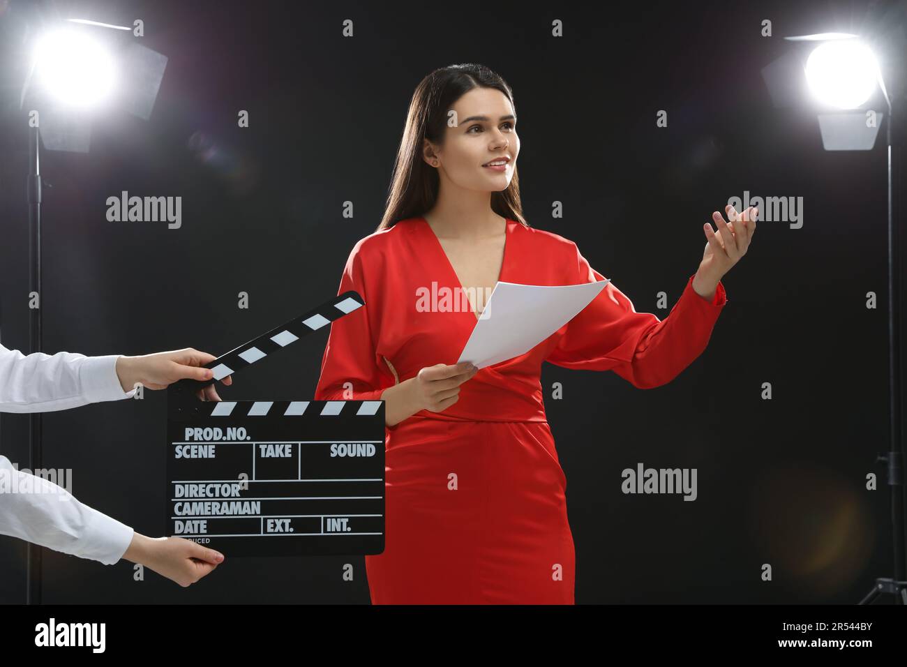 Emotional actress performing role while second assistant camera holding ...