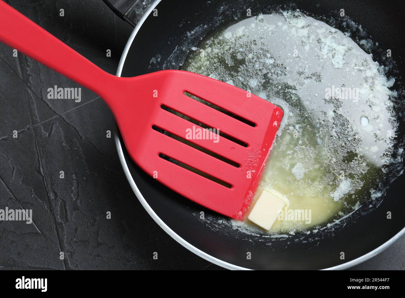 Melting butter in frying pan, top view Stock Photo - Alamy