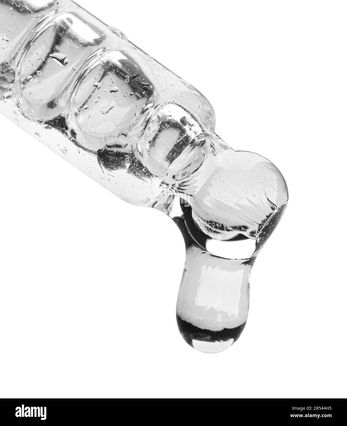 Dripping face serum from pipette on white background, closeup. Space ...
