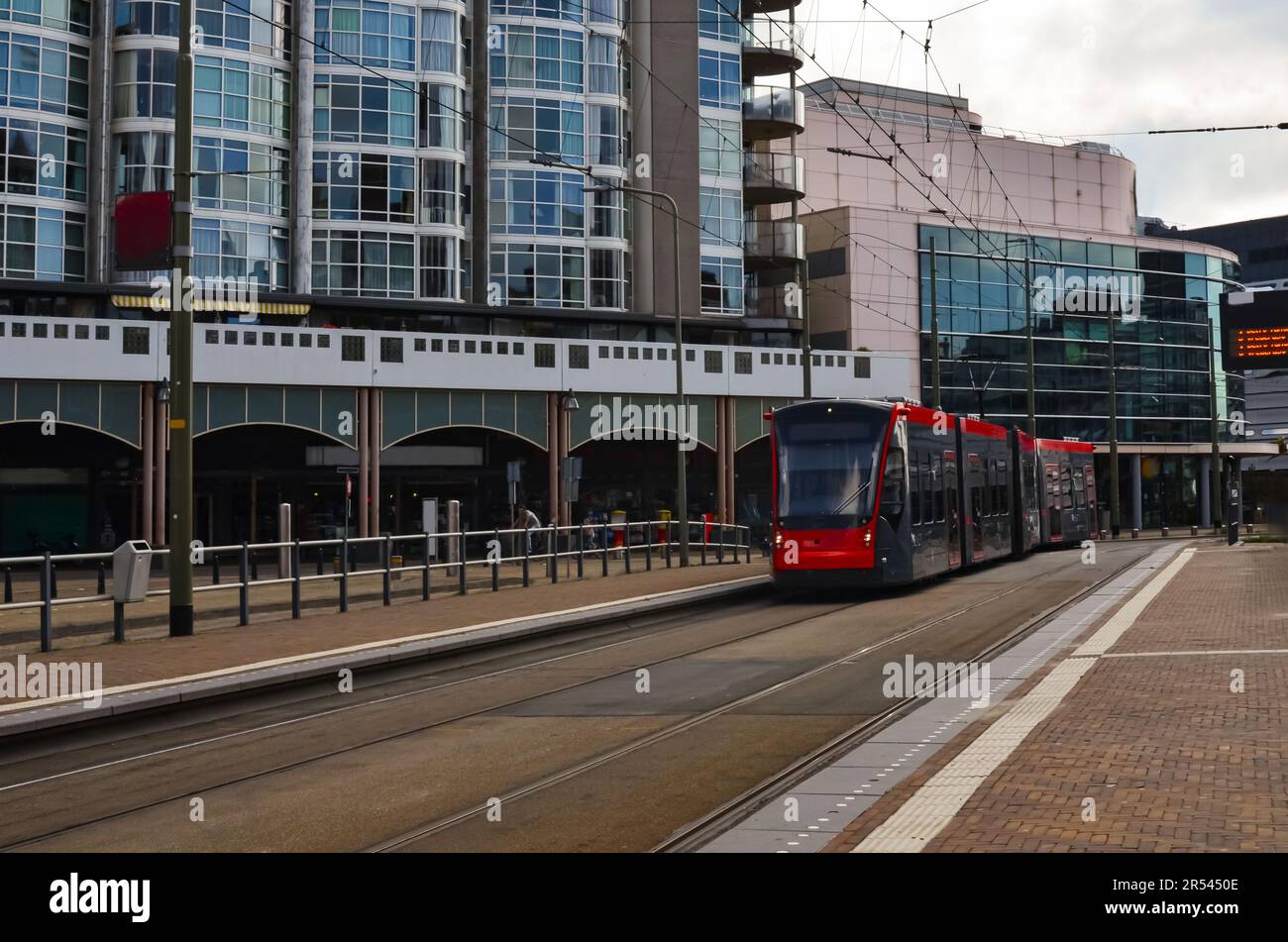 Red modern tram at station. Public transport Stock Photo - Alamy